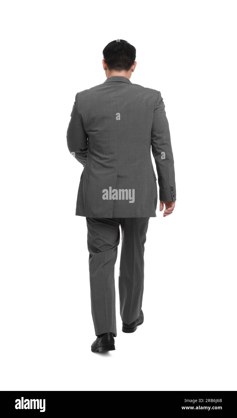 Businessman in suit walking on white background, back view Stock Photo ...
