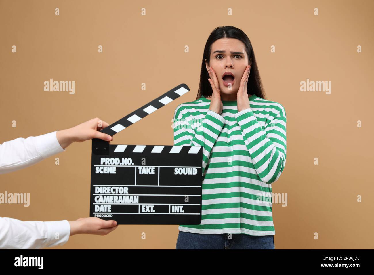 Emotional actress performing while second assistant camera holding ...