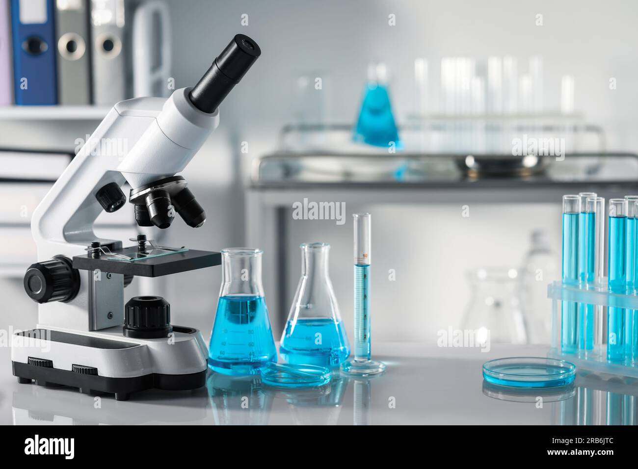 Different laboratory glassware, test tubes with light blue liquid and ...