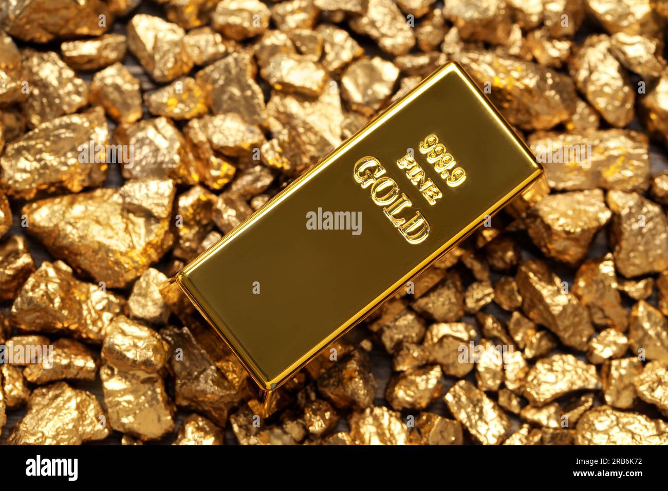 Shiny gold ingot on nuggets, top view Stock Photo - Alamy