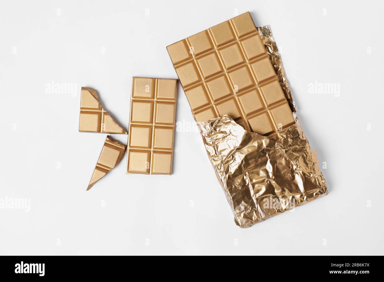 Shiny golden chocolate bar with foil on white background, top view ...