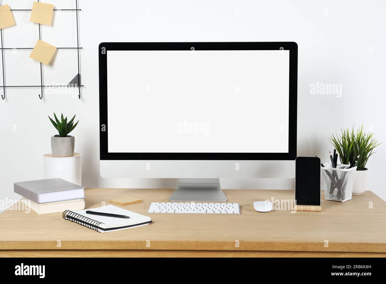 Cozy workspace with computer and stationery on wooden desk at home ...
