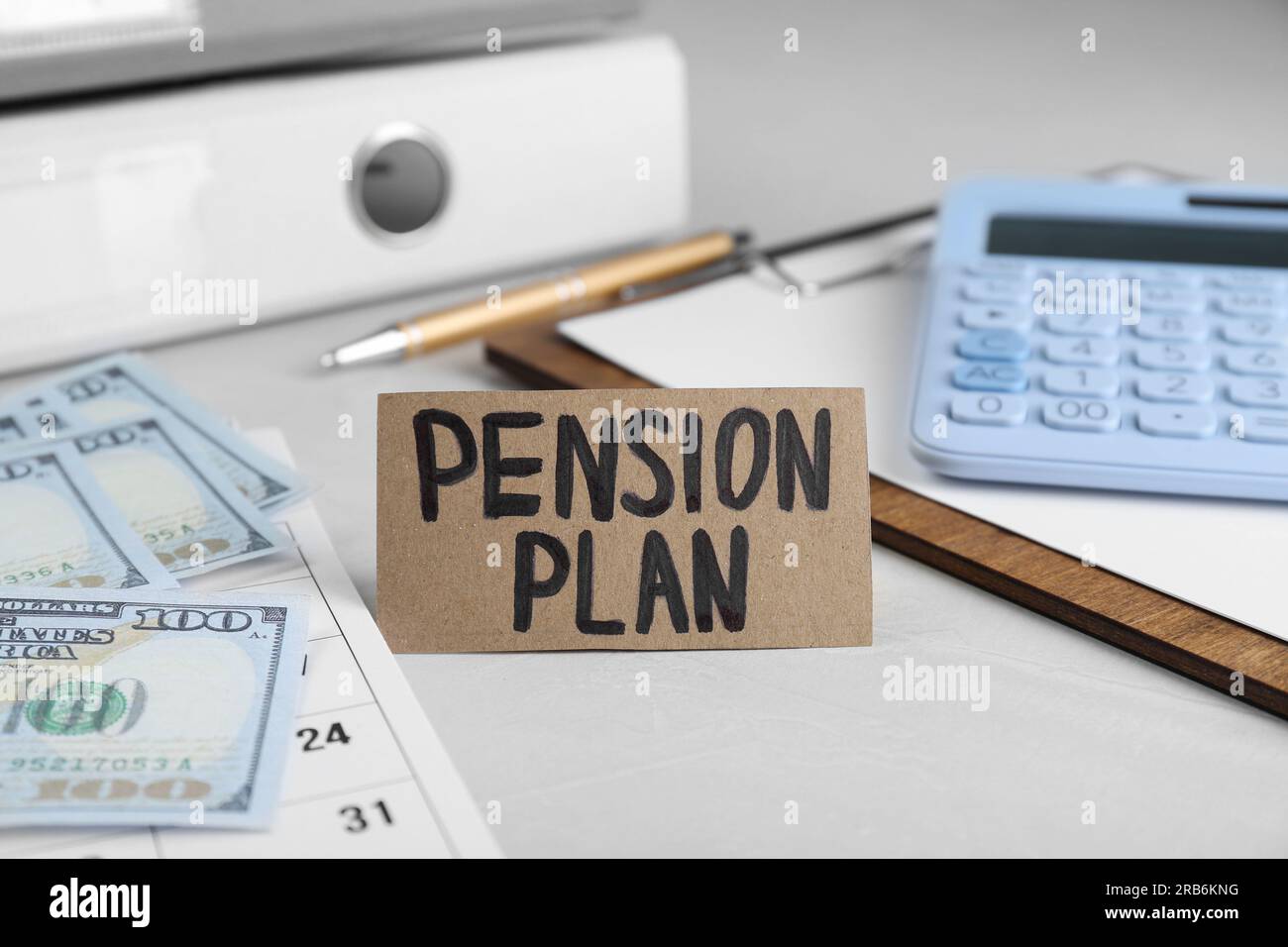 Card with phrase Pension Plan, calculator, dollar banknotes and ...