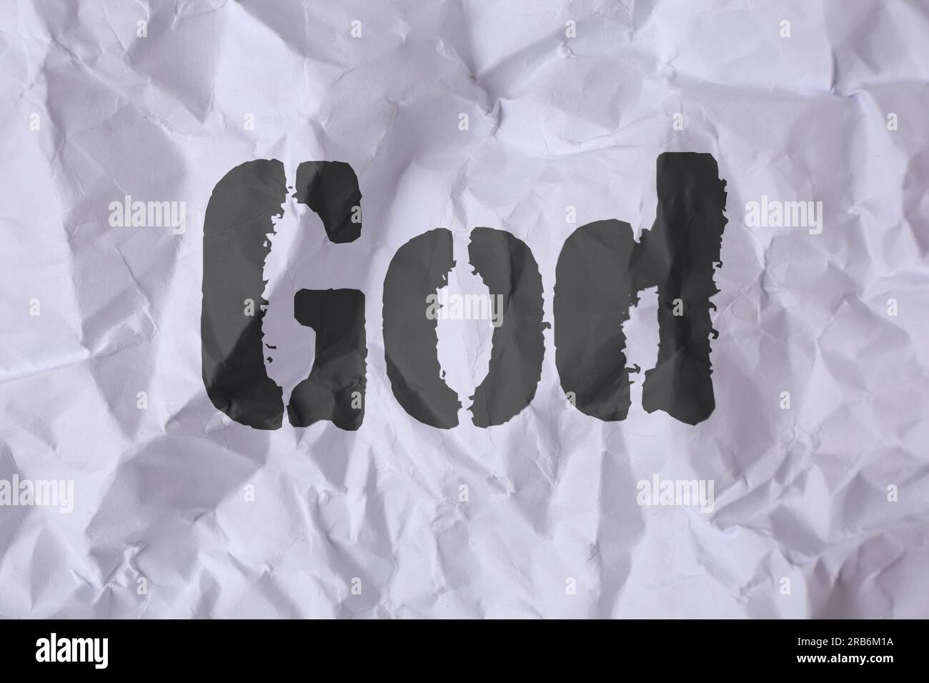 Crumpled paper with word God as background, top view Stock Photo - Alamy