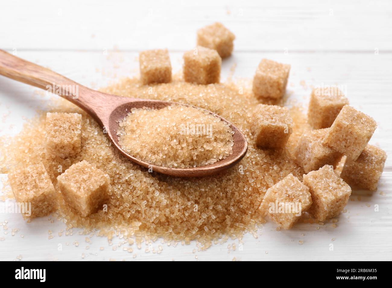 Different types of brown sugar on white wooden table, closeup Stock ...