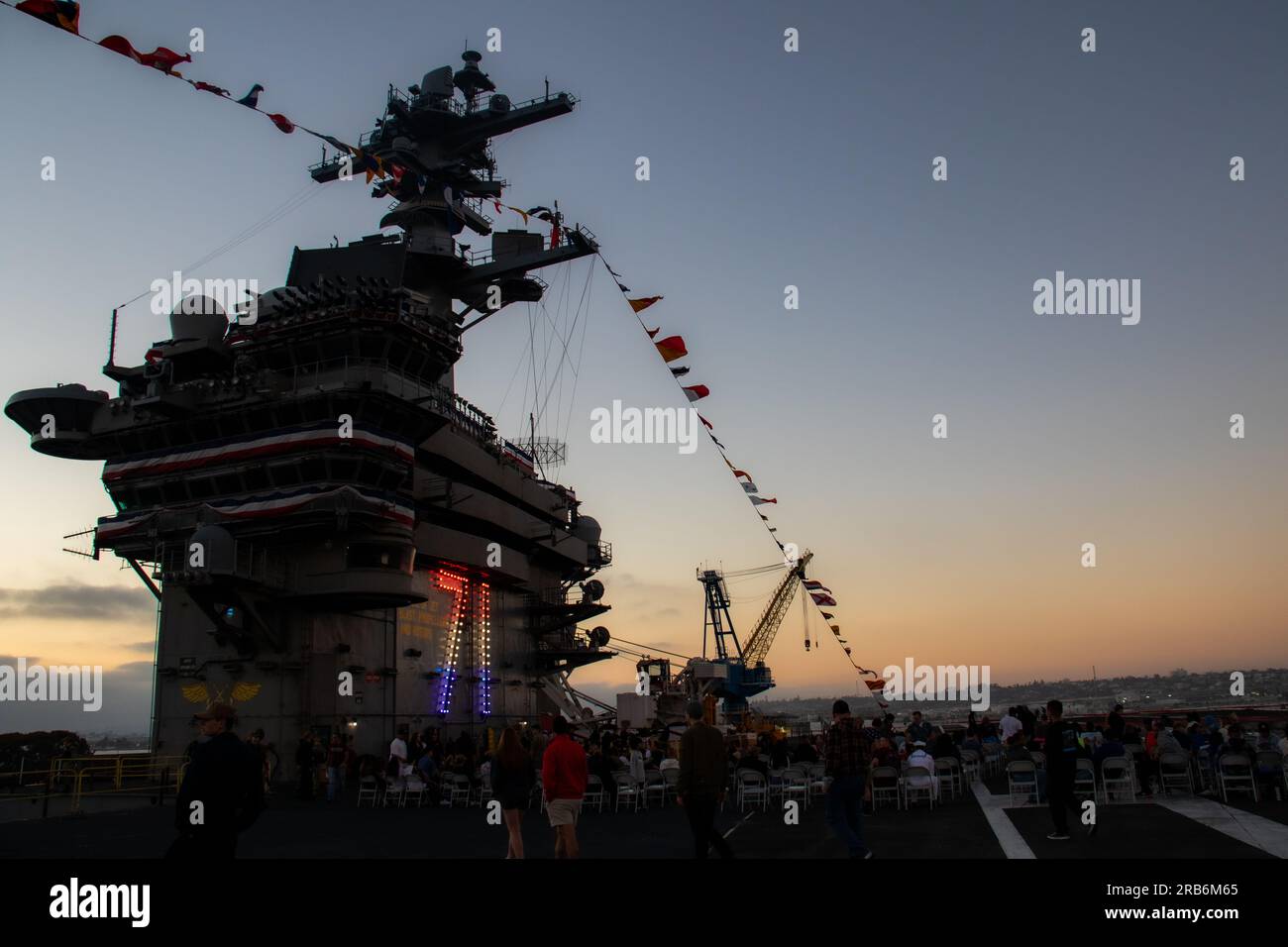 U.S. Sailors and guests observe fireworks from the flight deck of the ...