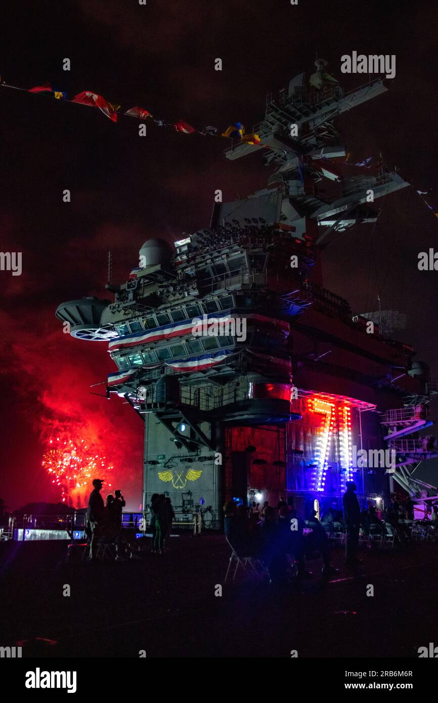 U.S. Sailors and guests observe fireworks on the flight deck of the ...