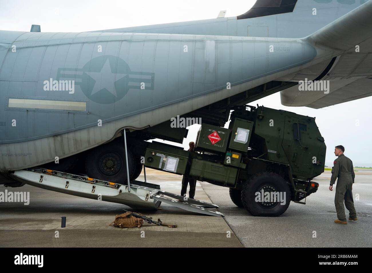 U.S. Marines with Marine Aerial Refueler Transport Squadron (VMGR) 152 guide an M142 High ...