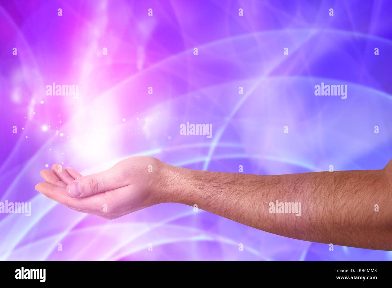 Aura phenomena. Man with flows of energy and lights around his hand ...