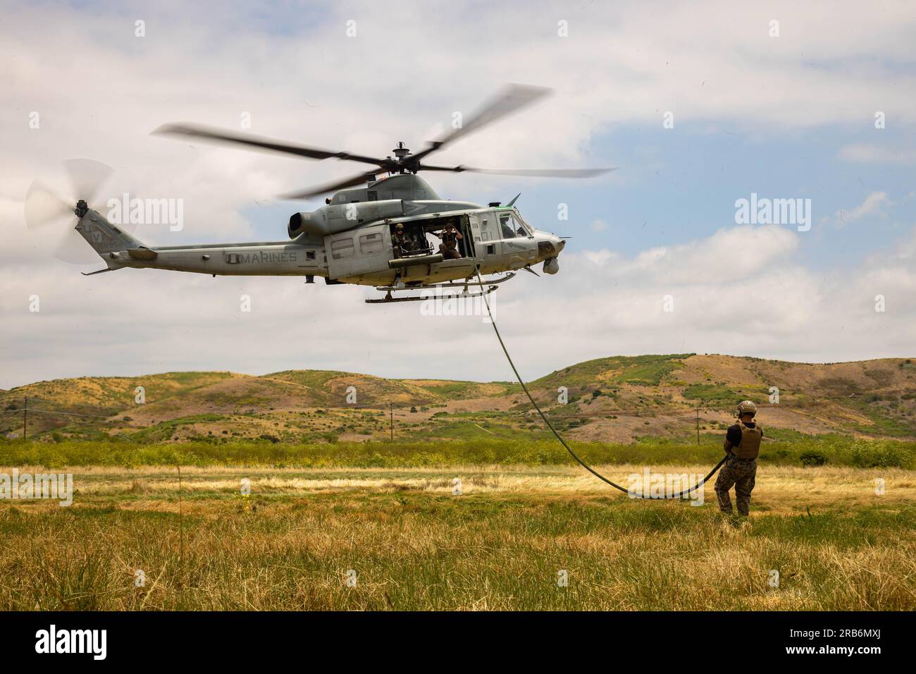 A U.S. Marine Corps UH-1Y Venom hovers above a landing zone in ...