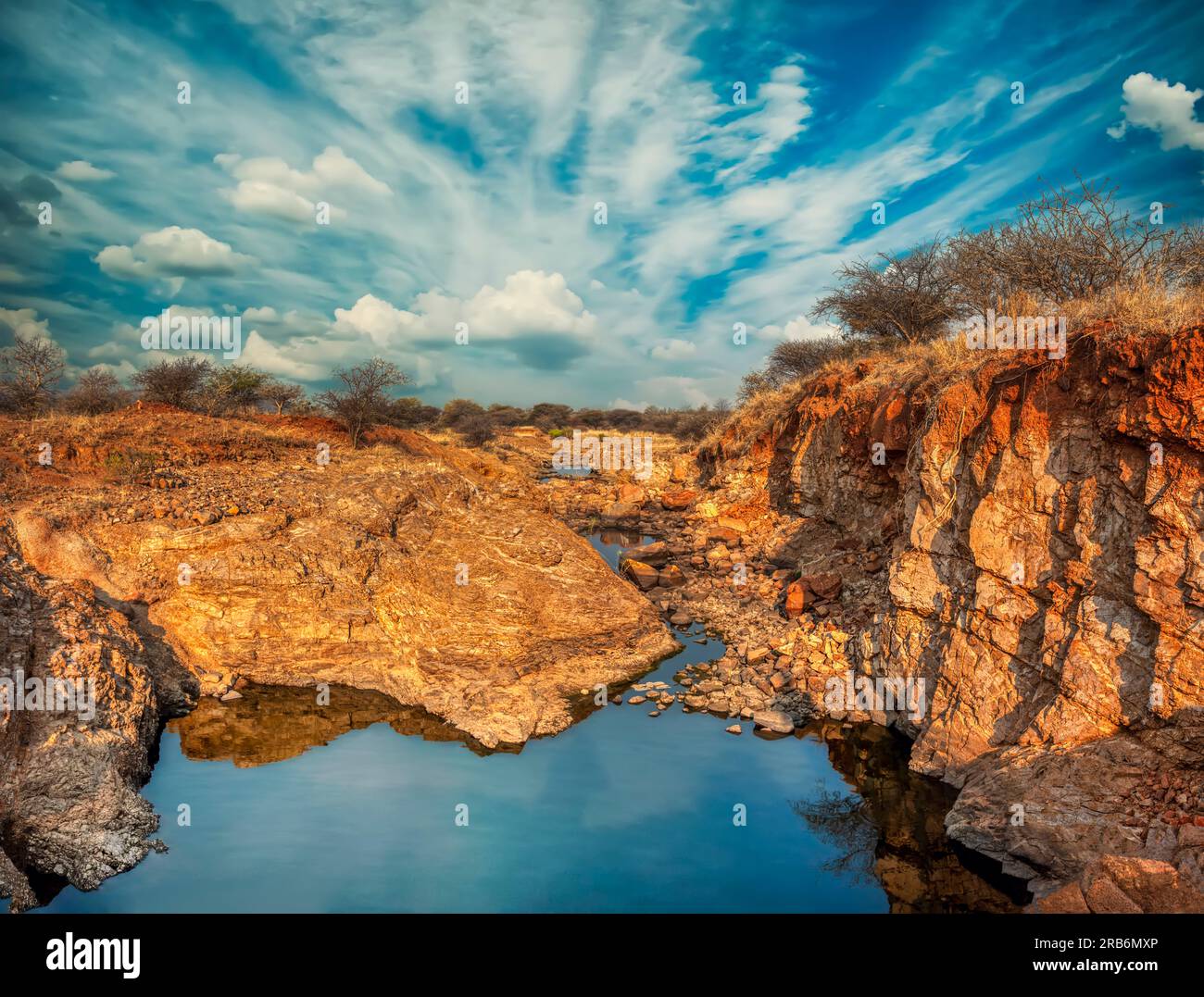 african landscape eroded red granite rock by the water in the river ...