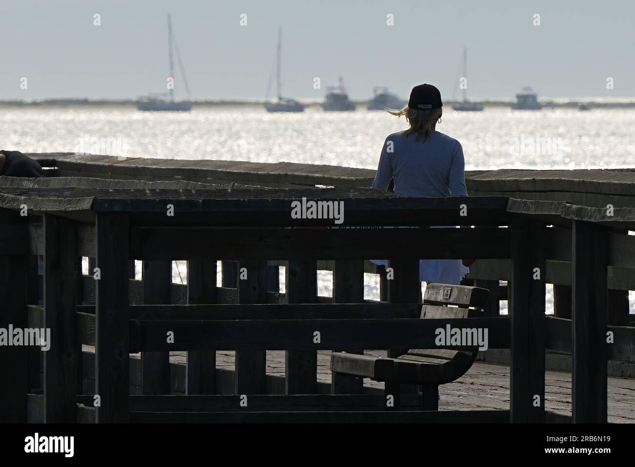 Woman walking on dock Stock Photo - Alamy