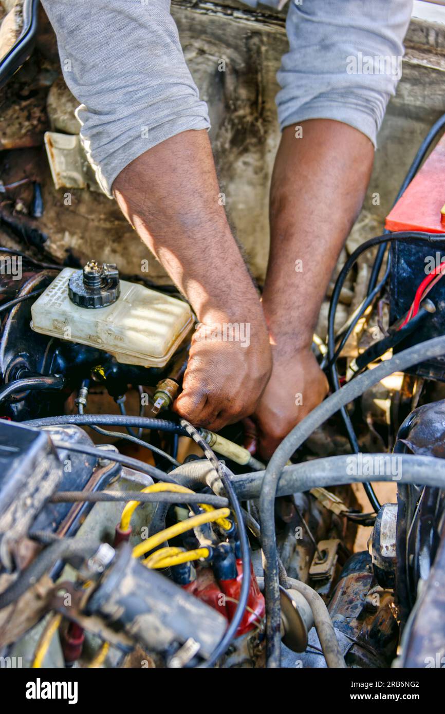 african mechanic fixing a vintage car outdoors in the yard Stock Photo ...
