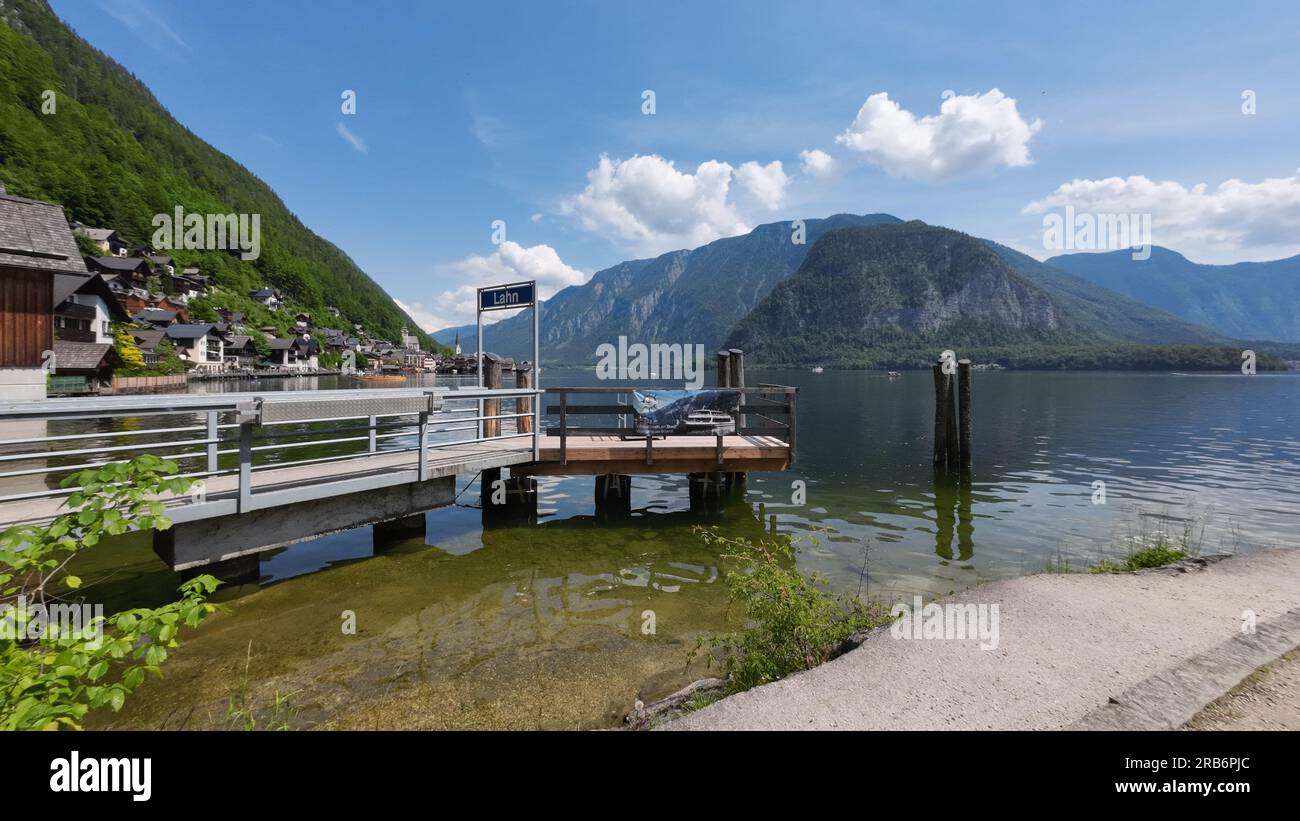 The bridge and lake in Hallstatt town, Austria, with mountain and blue ...