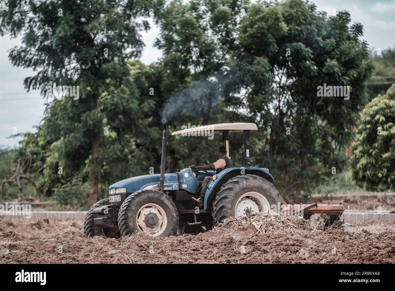Tractor plowing farmland farming in Kenya Landscapes East Africa Stock ...