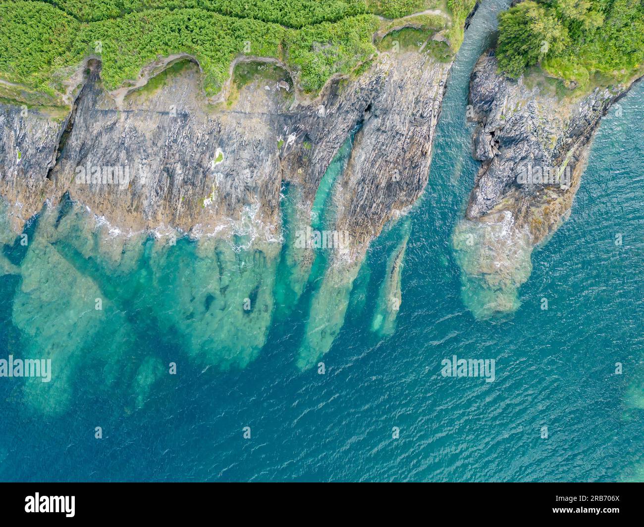 An aerial view looking down at the rocky coast of Pendennis Point near ...