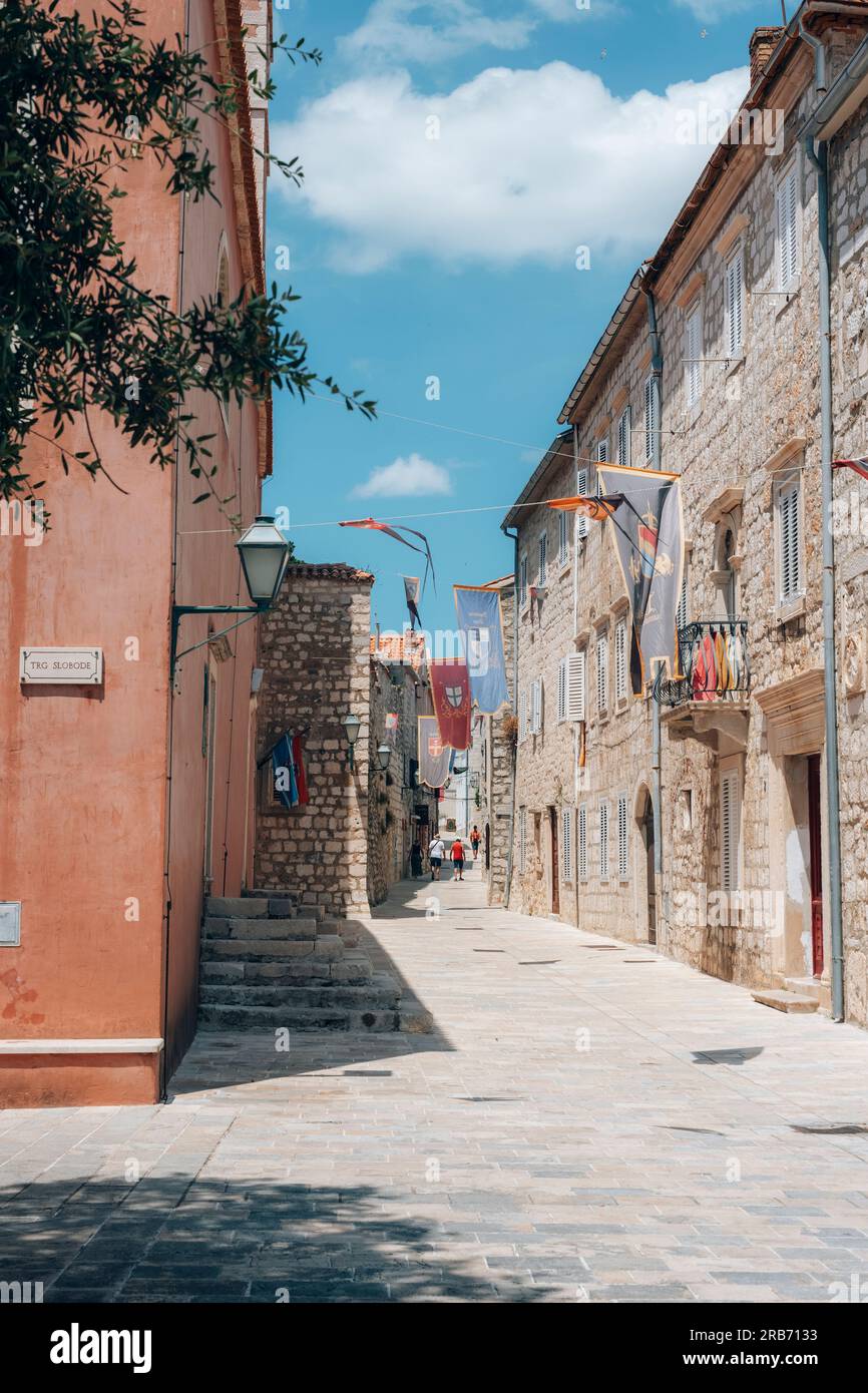 Rab Croatia - 4 July 2023: Narrow street of the old town of Rab on the ...