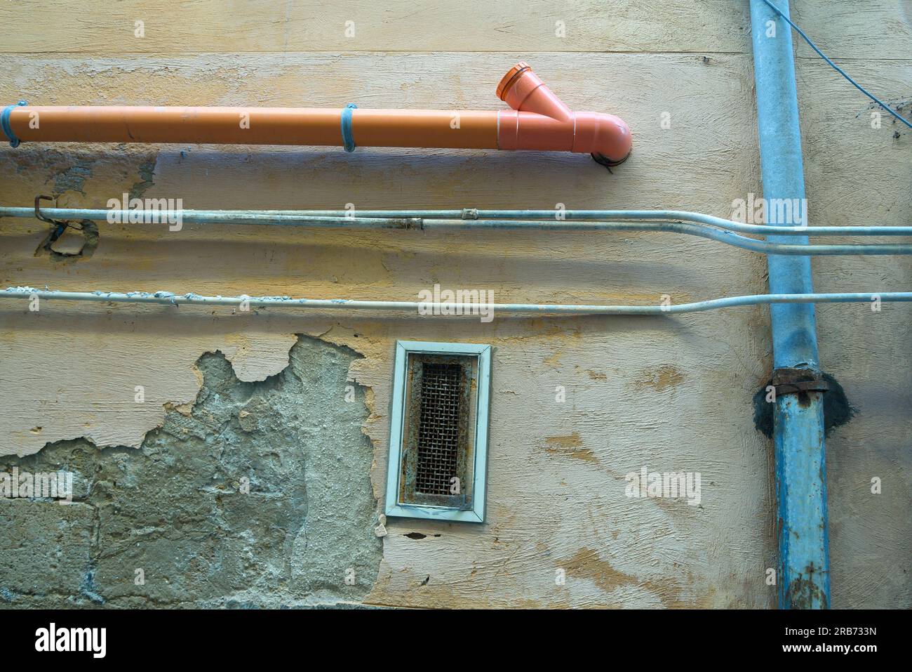 Pipes on the wall of a building in Italy Stock Photo - Alamy