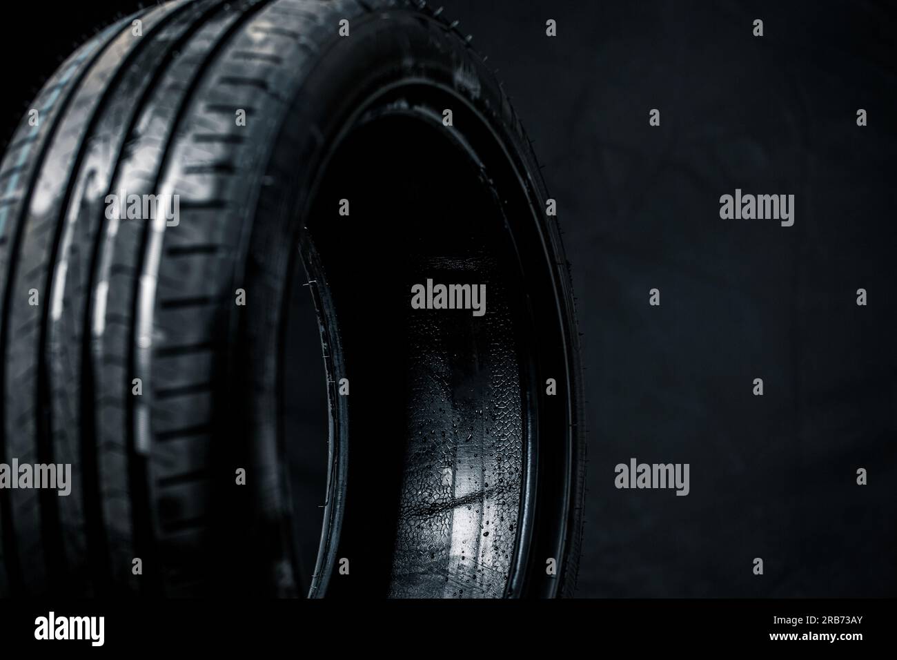 Stack of brand new high performance car tires on clean high-key white ...