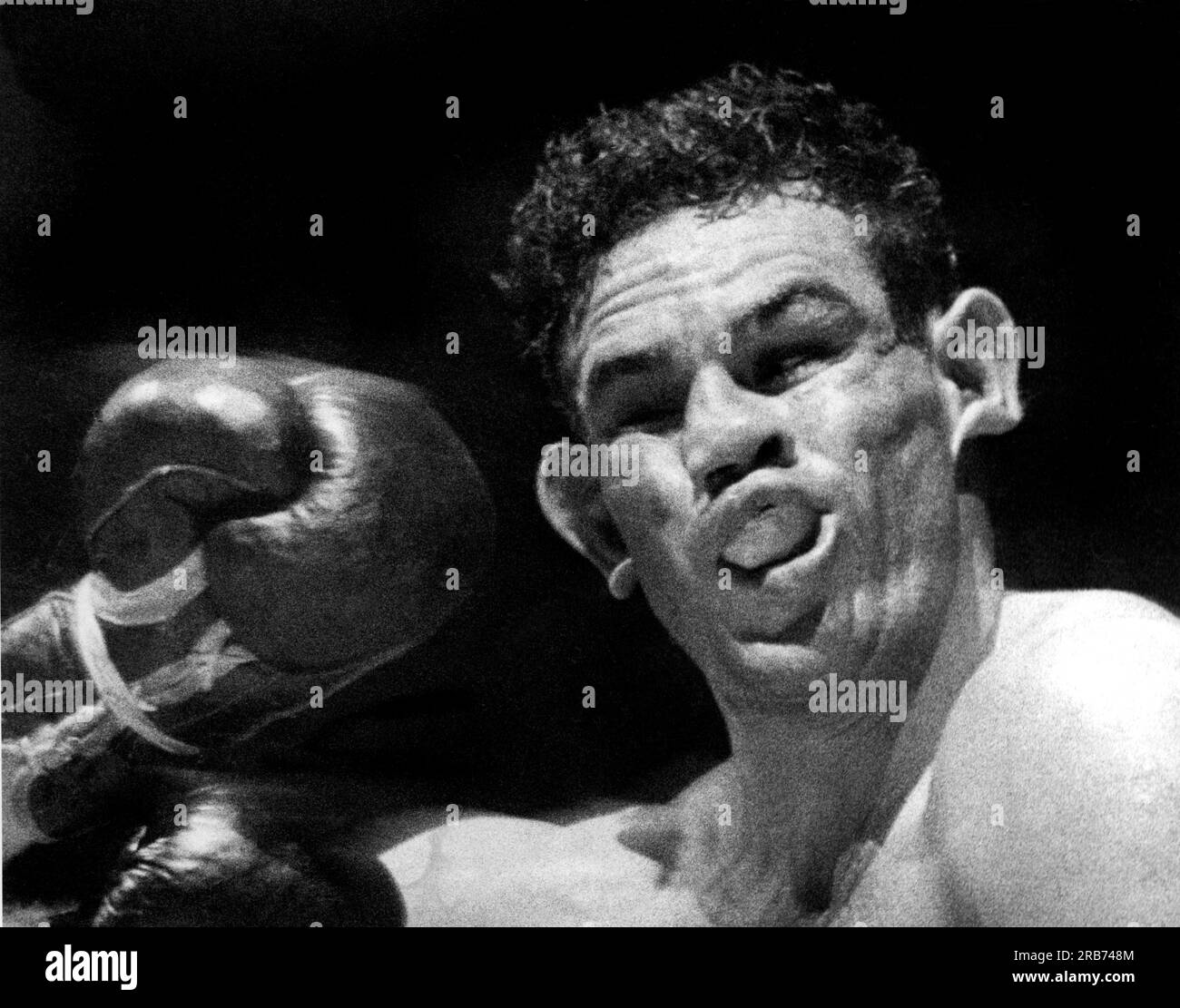 New York, New York: March, 1952. Ernie Durando catches a hard left hook from Paddy Young in the ...