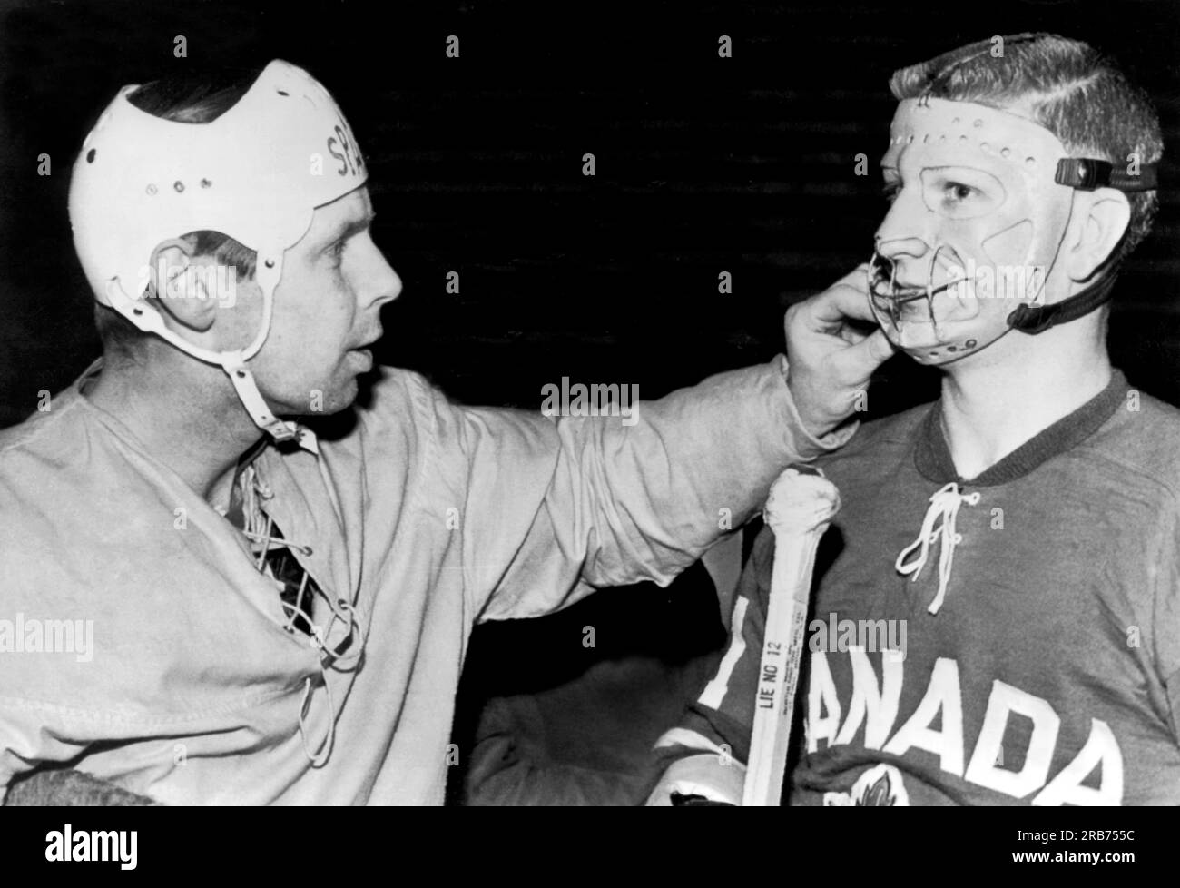 Stockholm, Sweden: February 6, 1961 Swedish hockey goalie Yngve Johansson inspects the mask of ...