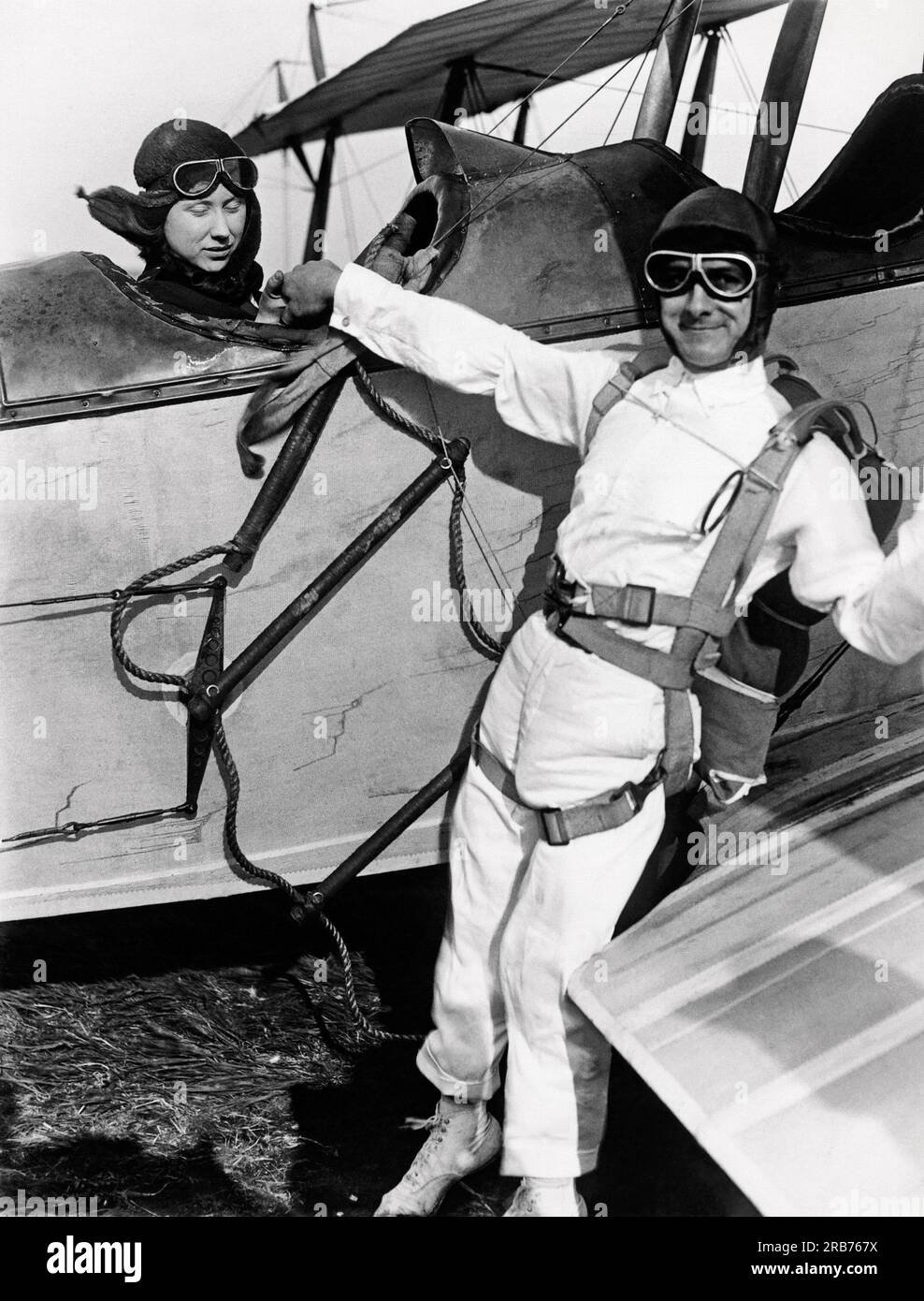 United States: c. 1927 A man ready to parachute from a biplane Stock ...