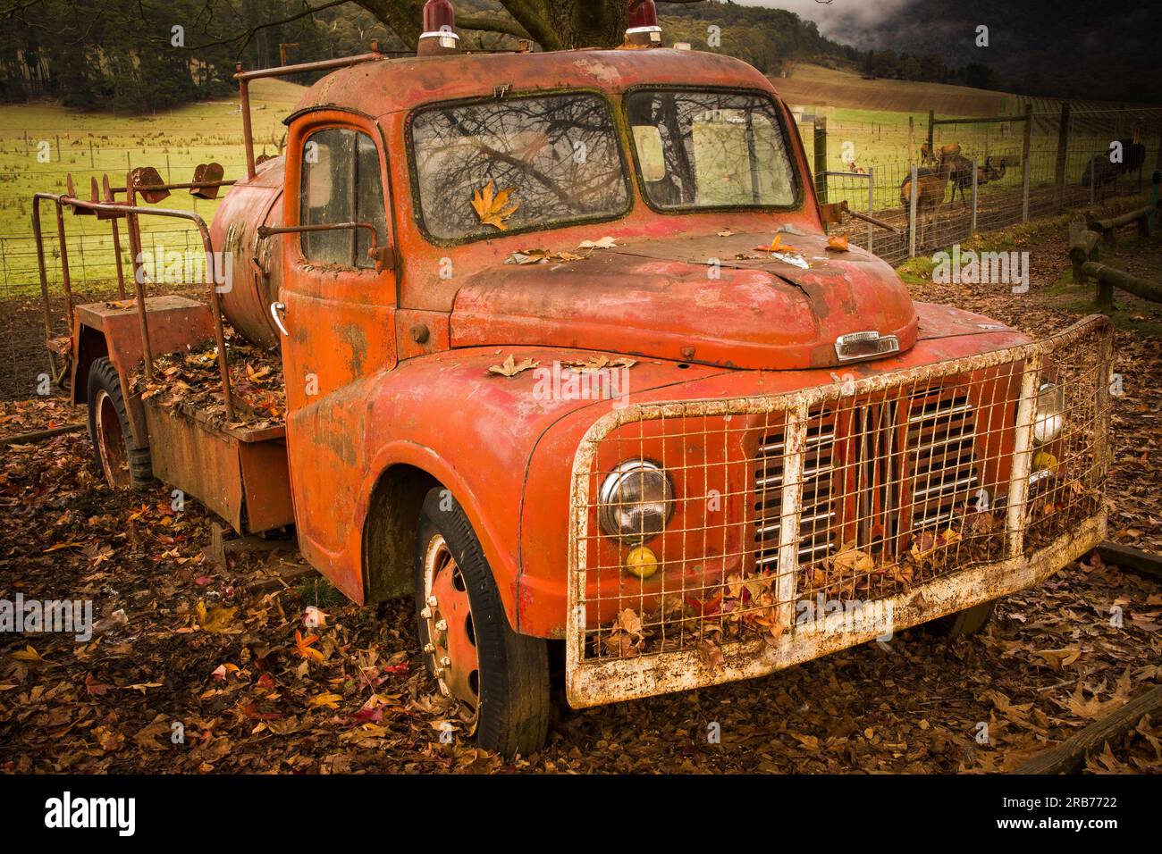 Old vintage Red Fire engine lying to rest in autumn leaves Stock Photo ...