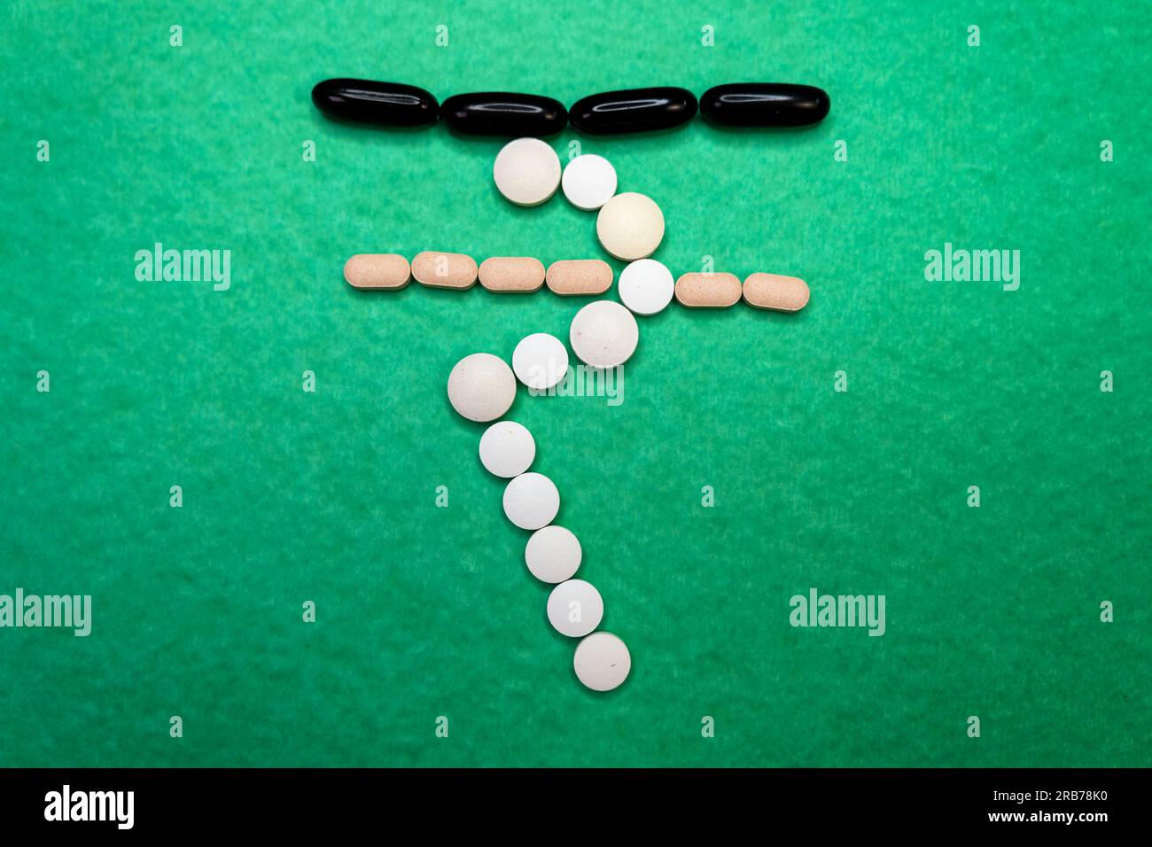 A close-up photo of a pile of colorful health care pills arranged in ...