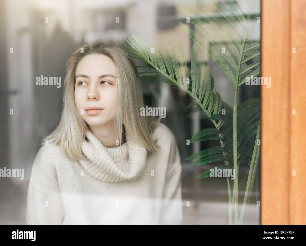 Sad girl near window thinking about something. Stressed lady feel ...
