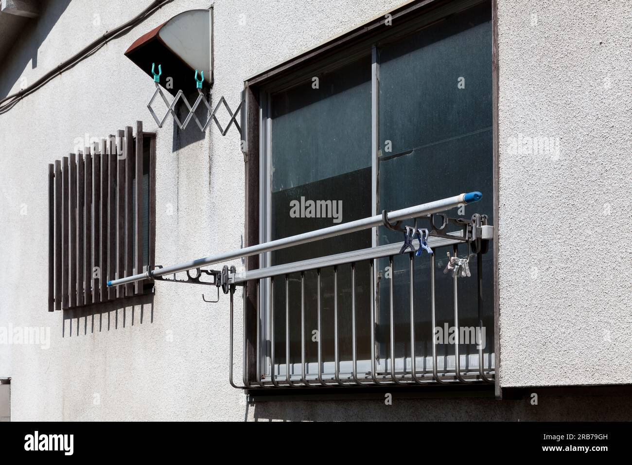 Detail image of laundry hangers and bars on the outside of an old house ...