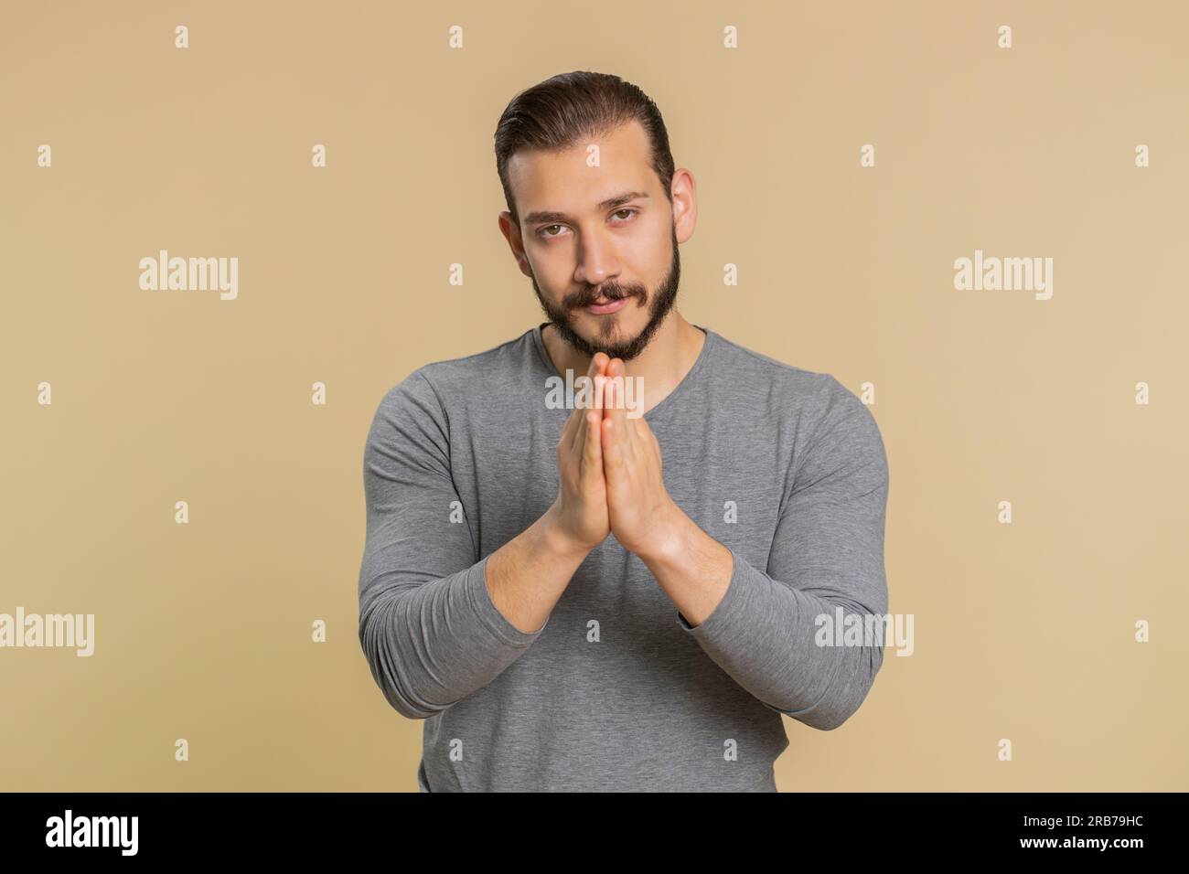 Please, God help. Lebanese young man praying, looking upward and making ...