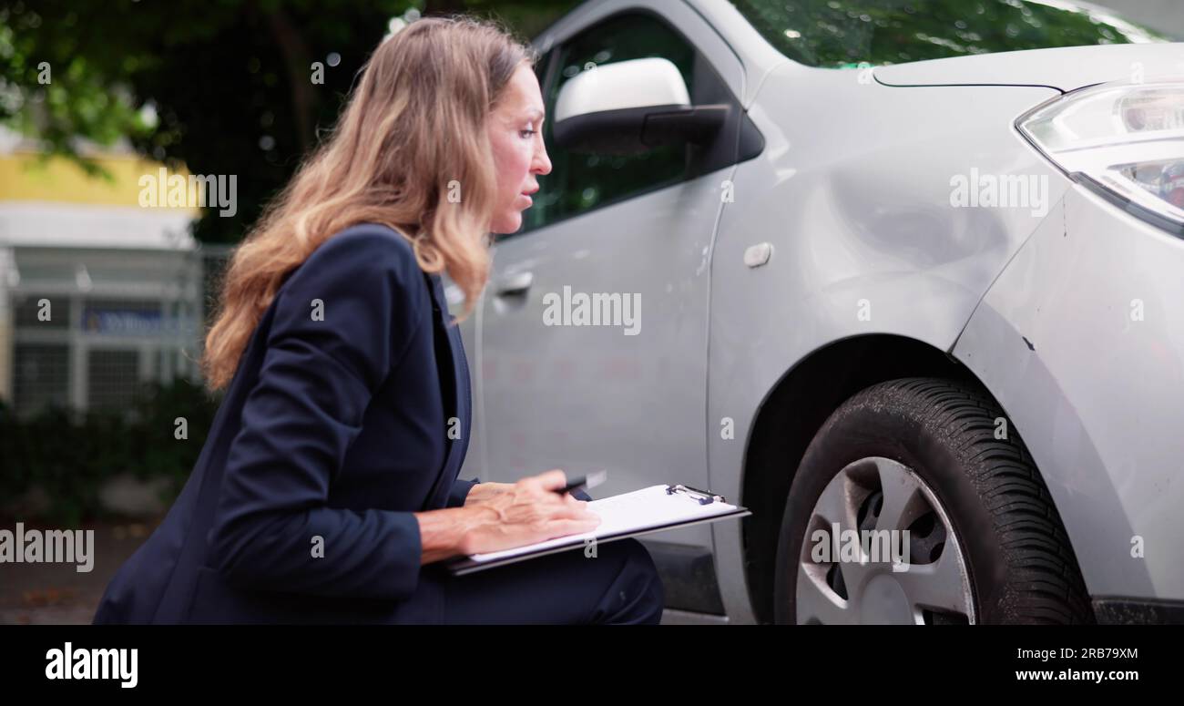 Insurance Agent Inspecting Damaged Car With Insurance Claim Form Stock ...