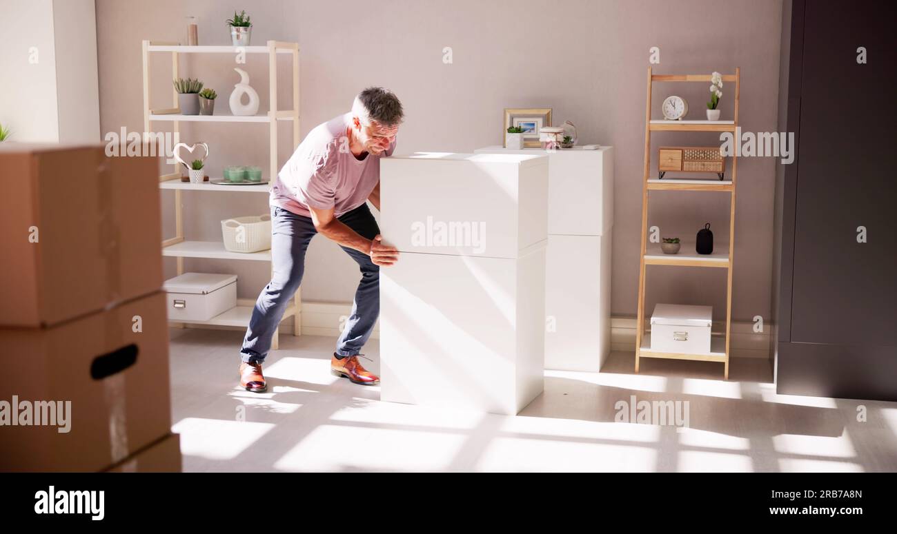 Man Carrying Furniture At Home. Move And Relocation Stock Photo - Alamy