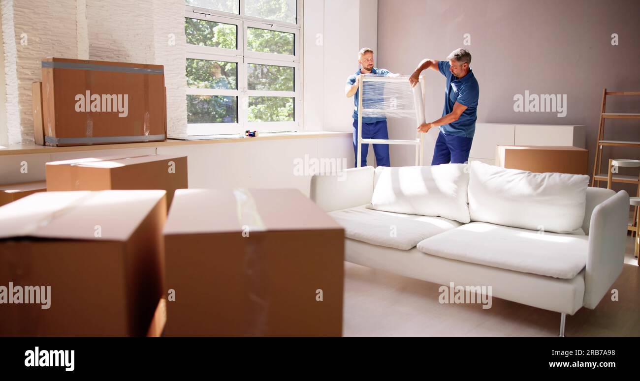 Professional Furniture Movers Wrapping. House Packing Service Stock ...