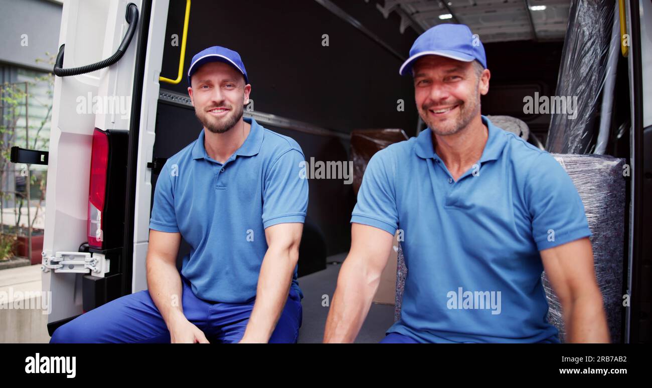 Furniture Removal Men. Relocation Delivery Truck On Street Stock Photo ...