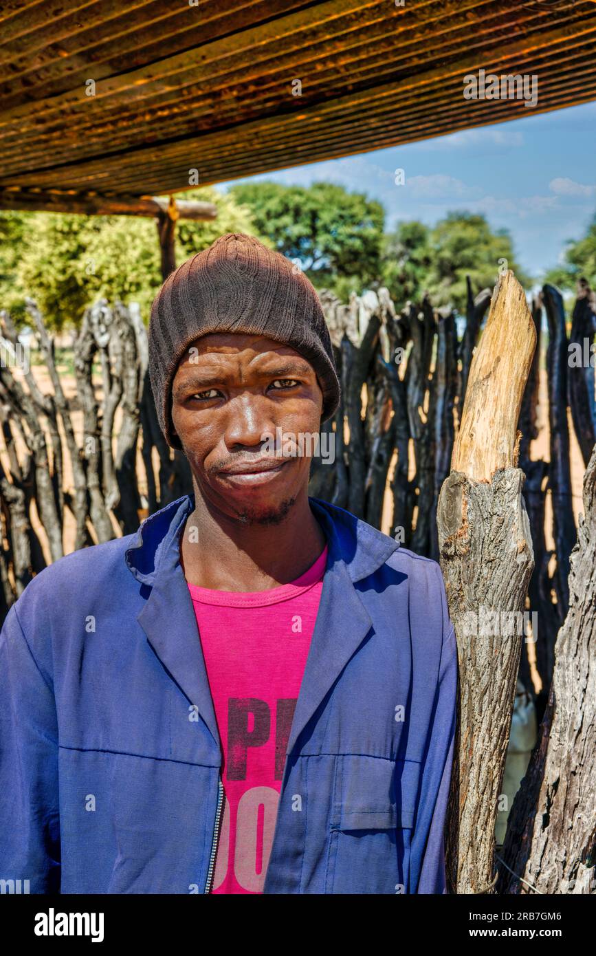 Portrait of an African village man standing in the yard, outdoors ...