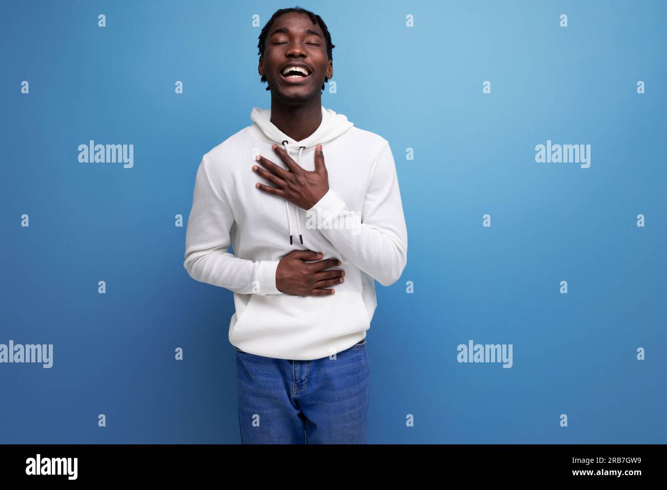 kind african 20s man with dreadlocks on blue background Stock Photo - Alamy