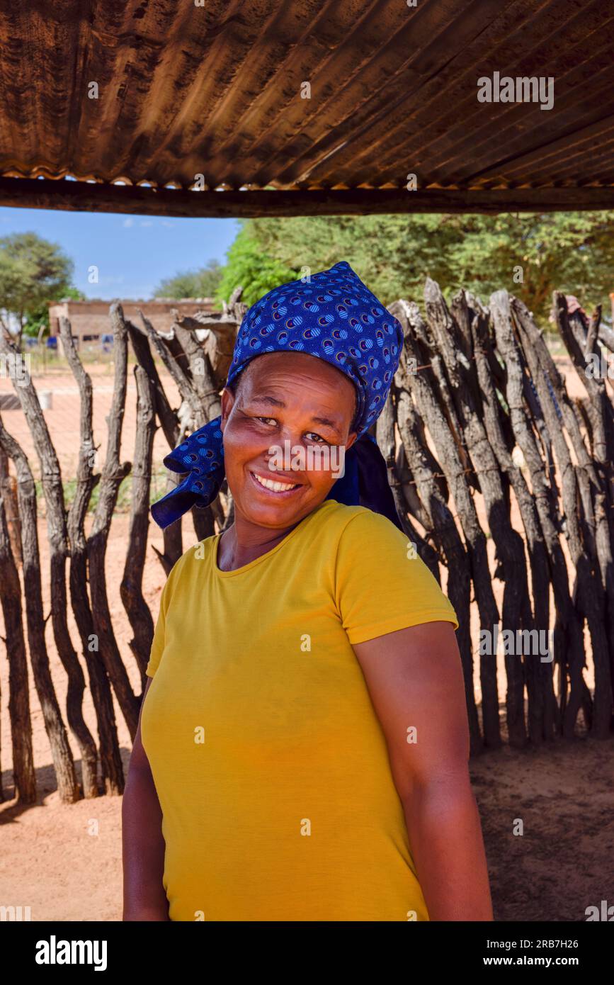Portrait of an African village woman standing in the yard, outdoors ...