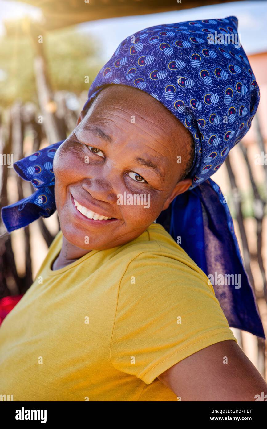 Portrait of an African village woman standing in the yard, outdoors ...