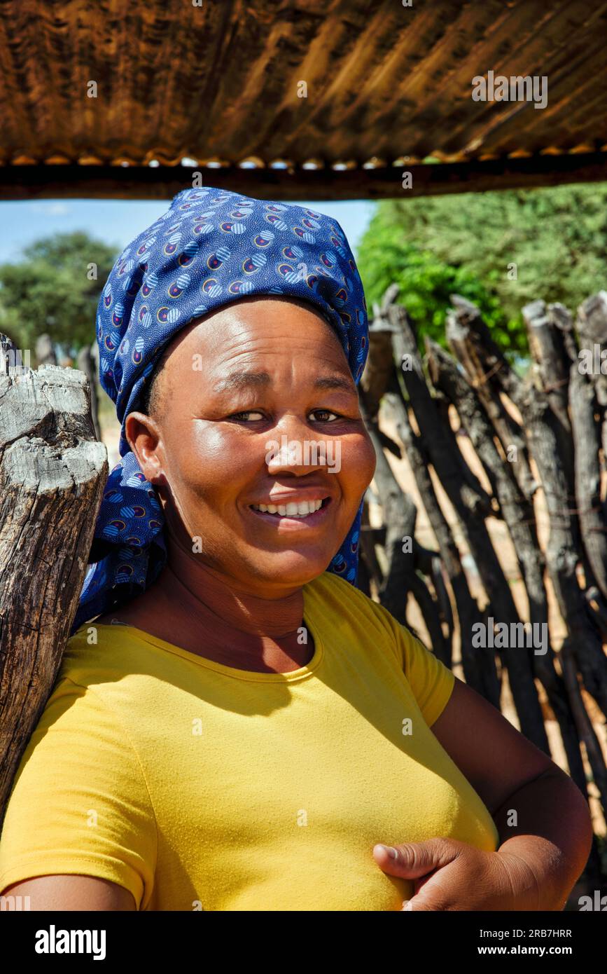 Portrait of an African village woman standing in the yard, outdoors ...