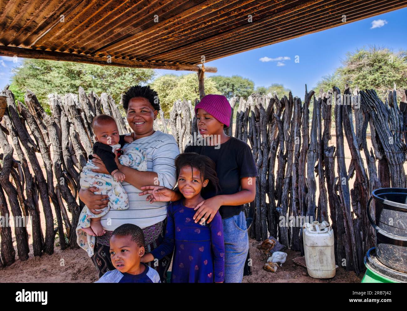 Portrait of an African village family in the yard, outdoors kitchen in ...