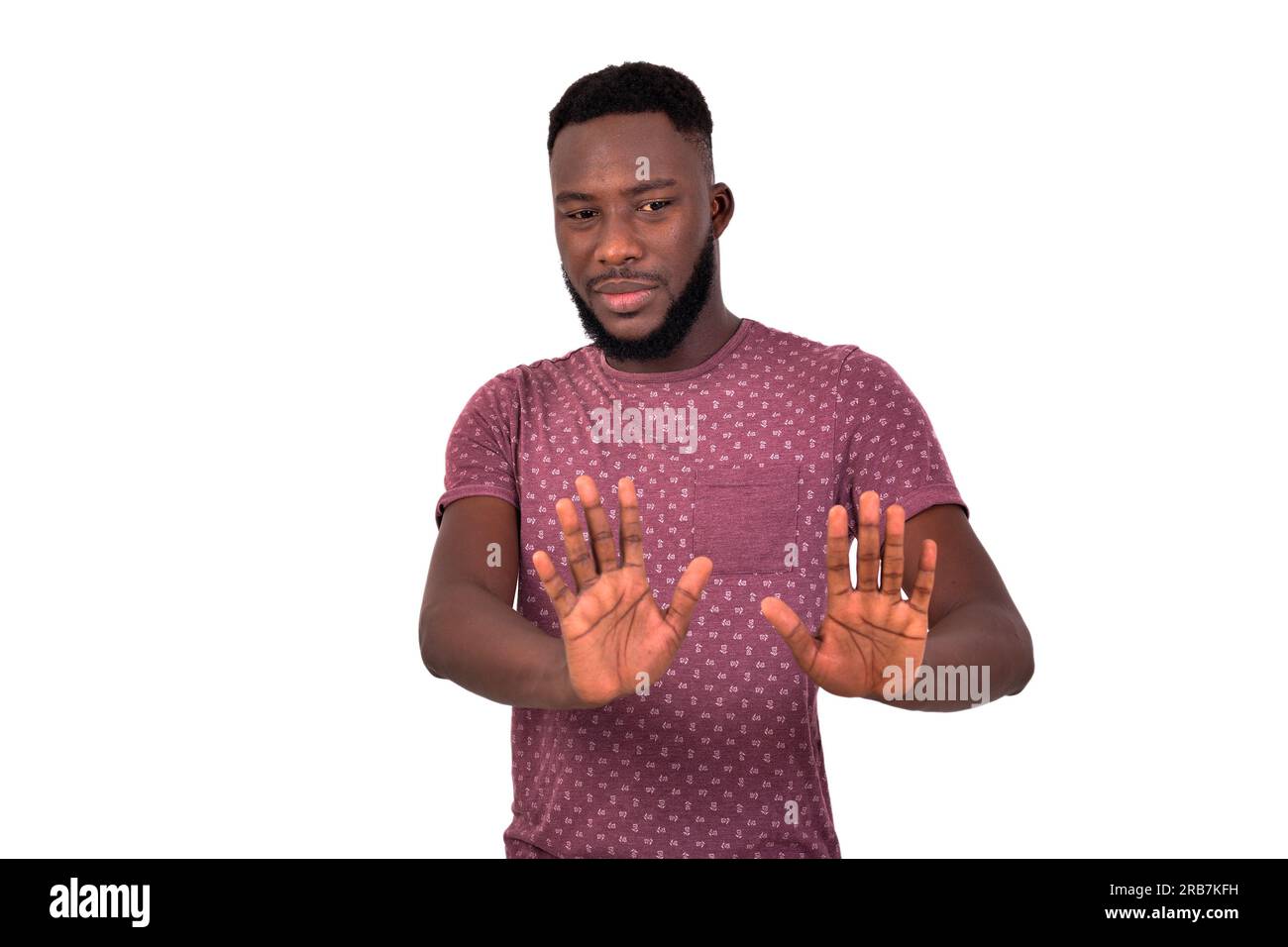 portrait of a frustrated young man making a stop gesture with his hands ...