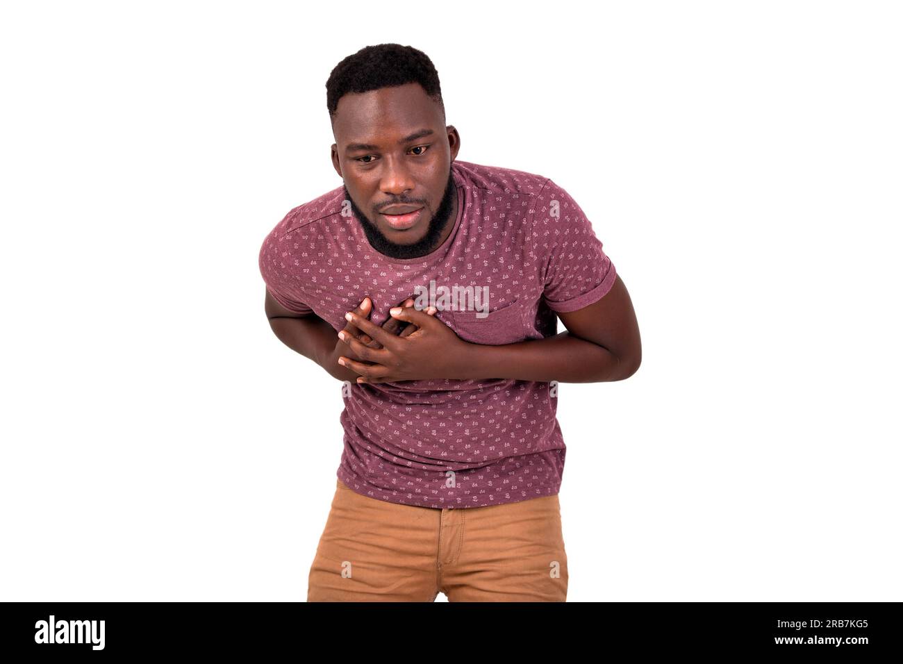 portrait of a sick young man holding both hands on his chest suffering ...