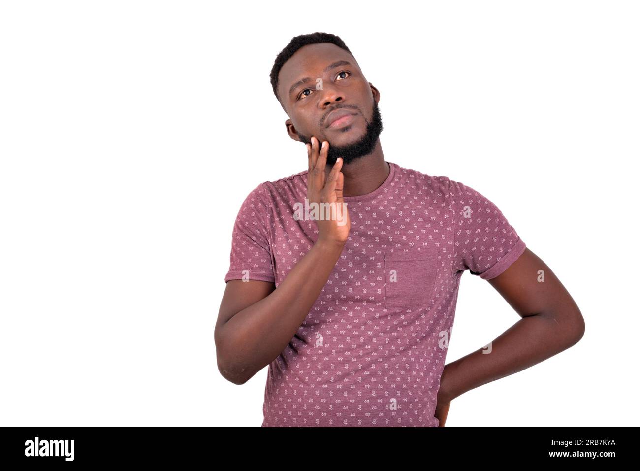 portrait of a handsome young man standing and thinking. isolated on ...