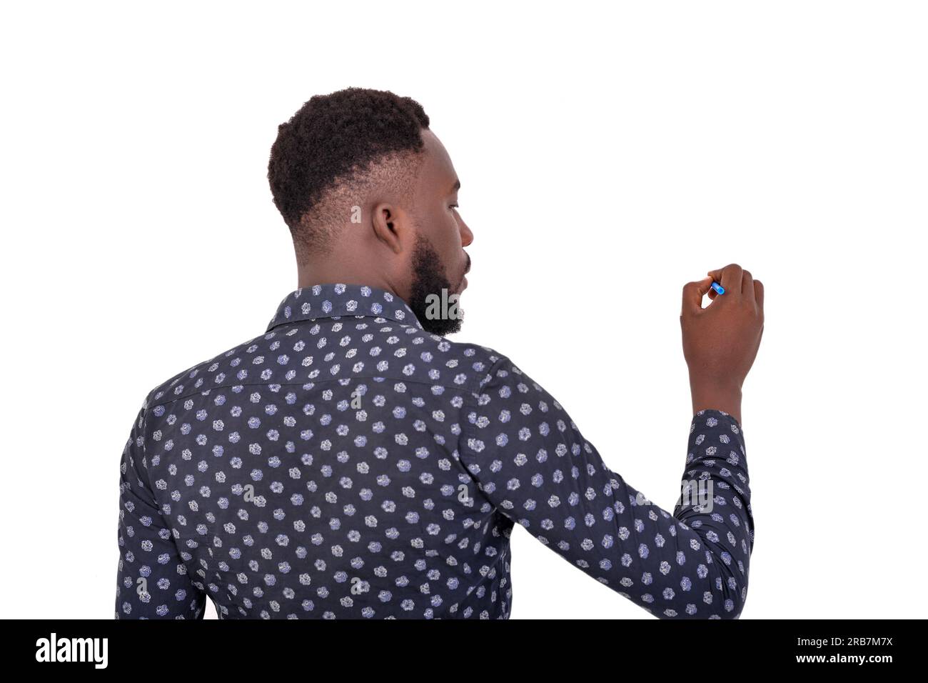 portrait of a young male teacher writing on a whiteboard with a pen ...