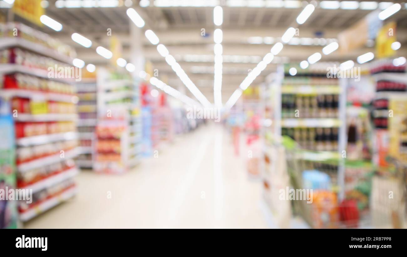 Abstract blur supermarket aisle with colorful product on shelves ...