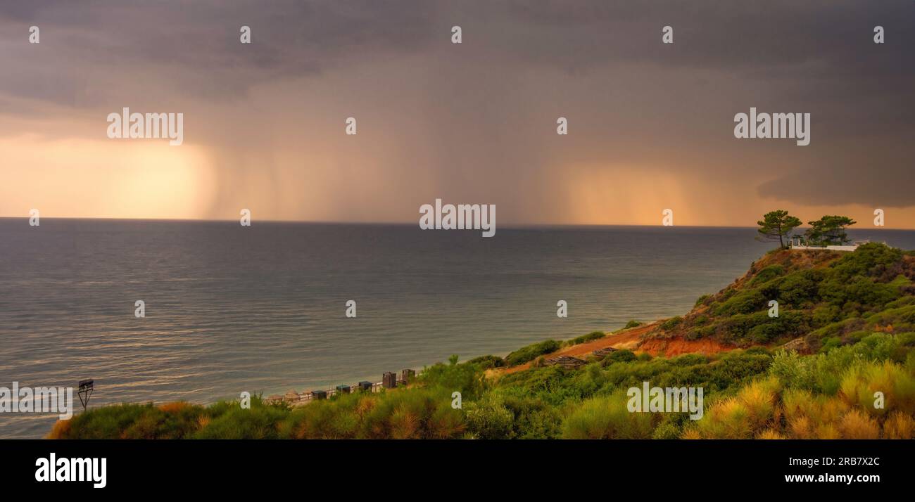 Storm with heavy rain seen from the shore as it approaches land in ...