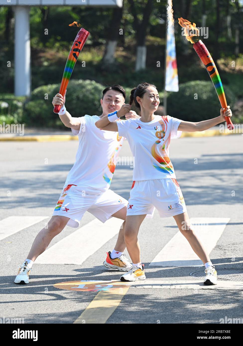 Chengdu, China's Sichuan Province. 8th July, 2023. Torch bearers Deng Bowen (L) and Wang ...