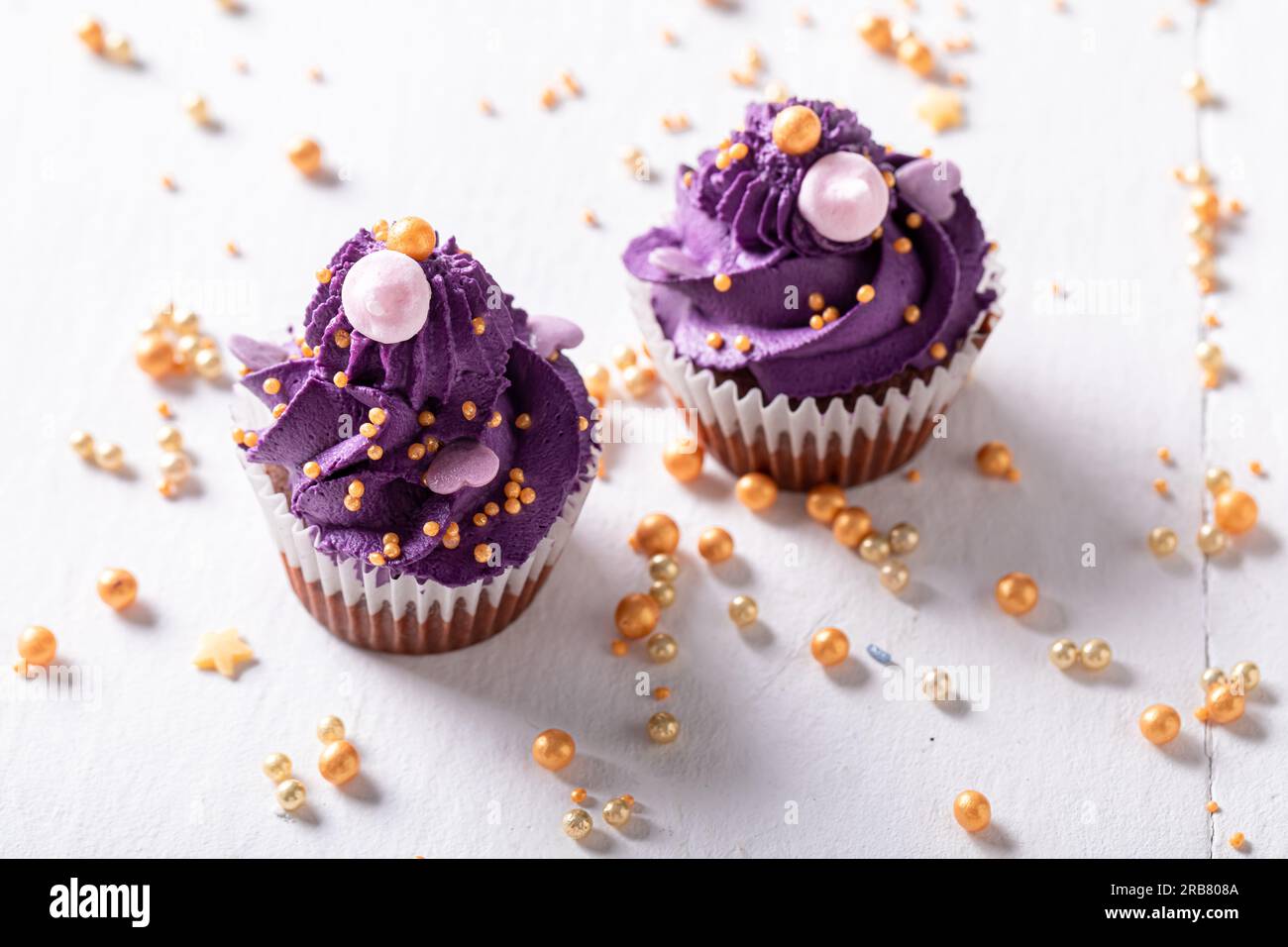 Beautiful and unique cupcakes with violet whipped cream. Purple dessert ...