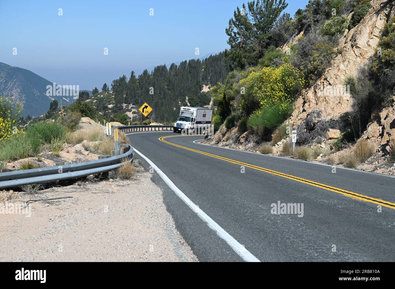A lorry coming around a sharp bend on California State Route 18 Stock ...